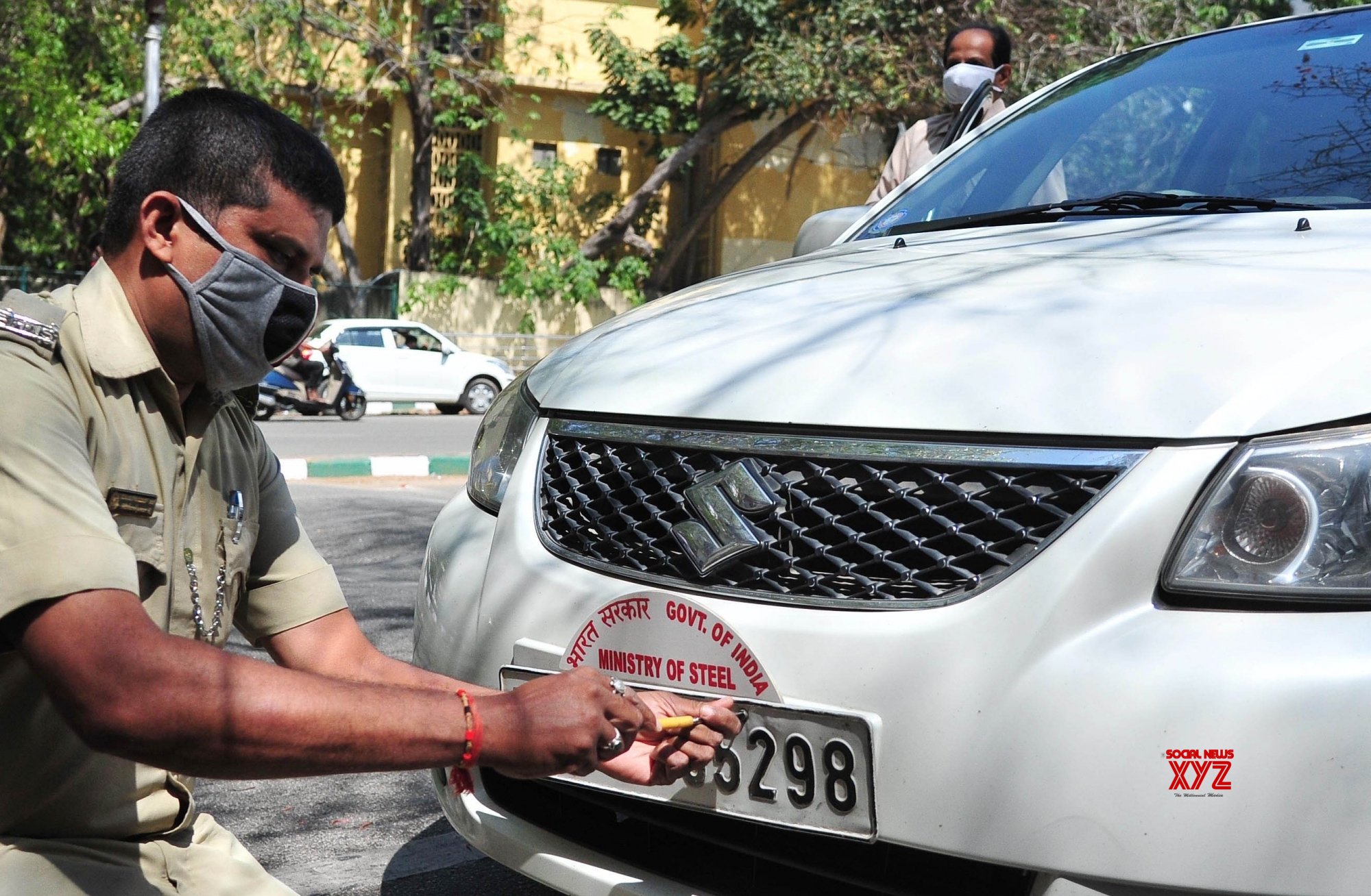 RTO officials removing Names and Designations plates on the vehicle ...