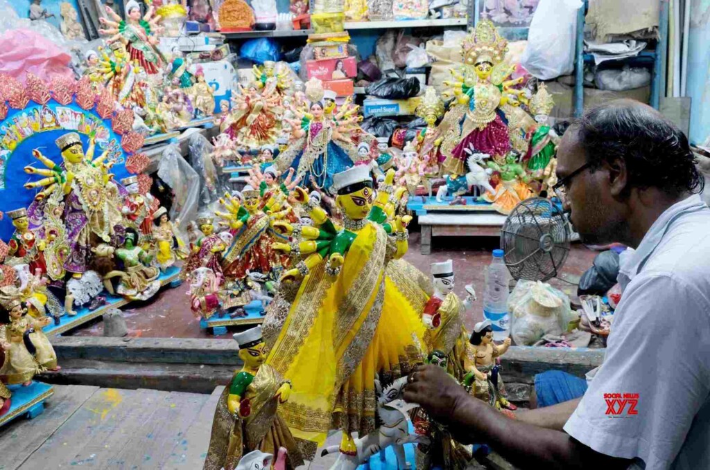 Kolkata: An artist decorates a miniature idol of Goddess Durga at ...
