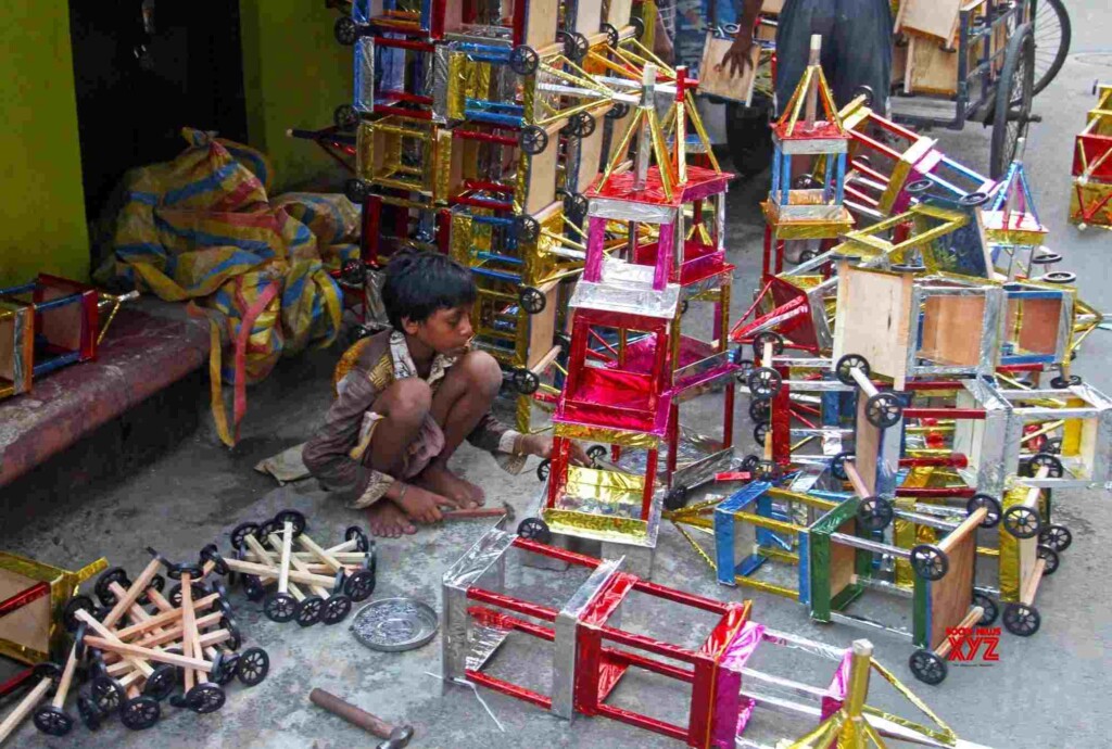 Kolkata : - A young boy prepares wooden Raths ahead of the 'Rath Yatra ...